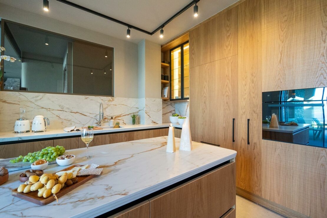 A spacious, modern and organic kitchen featuring wood and Dekton ...