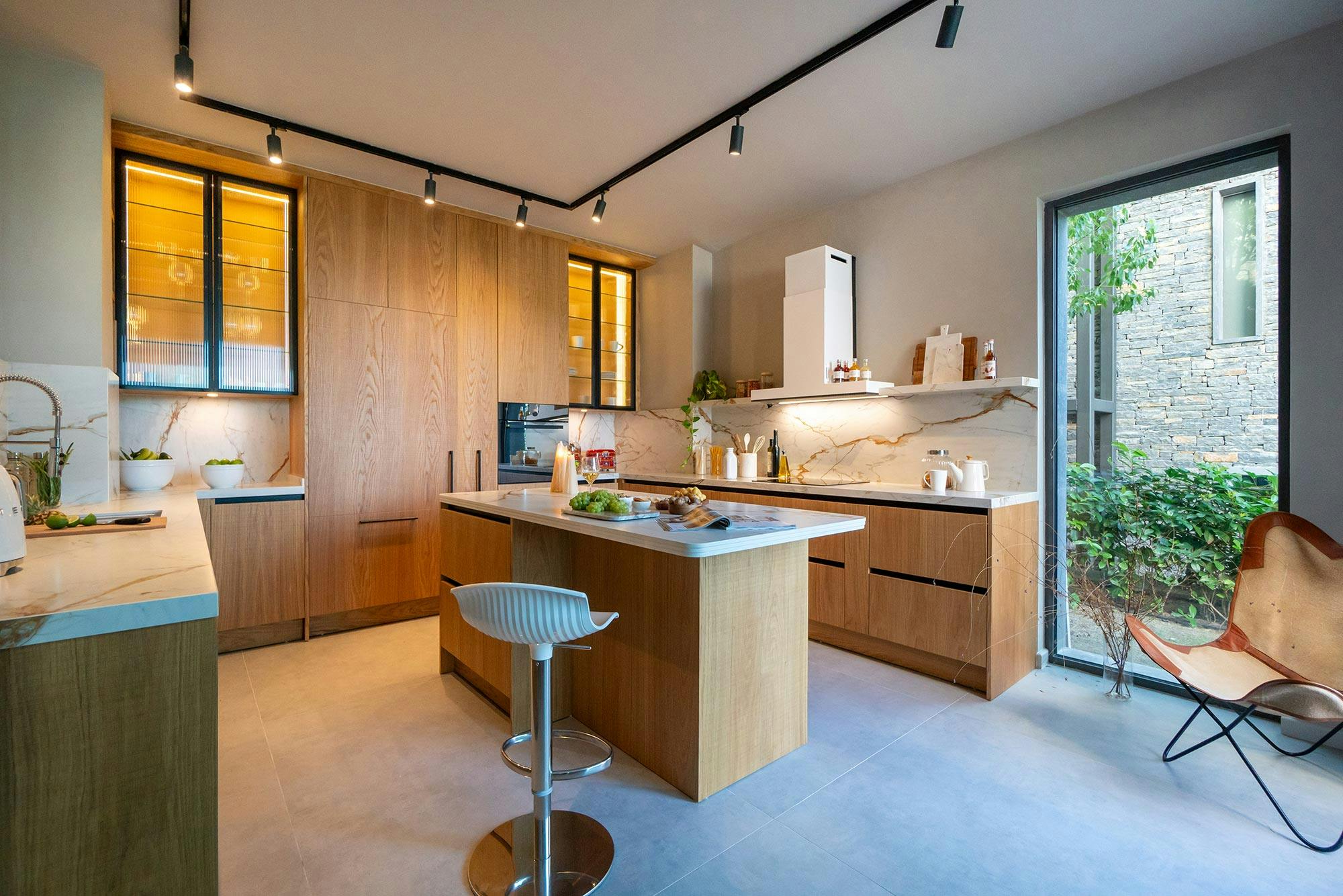 A spacious, modern and organic kitchen featuring wood and Dekton ...