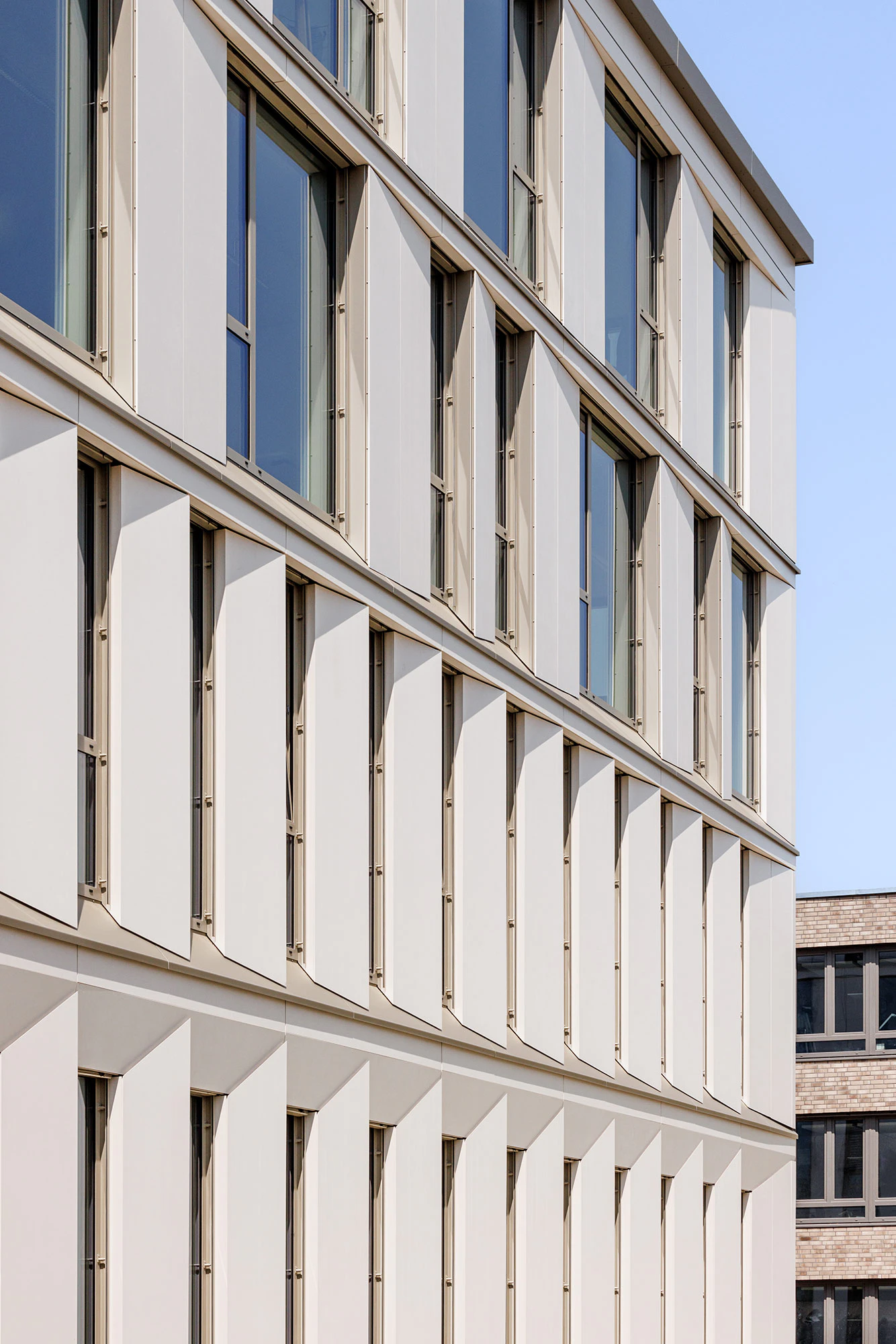Only two façade elements (recessed windows and slanted Dekton panels ...