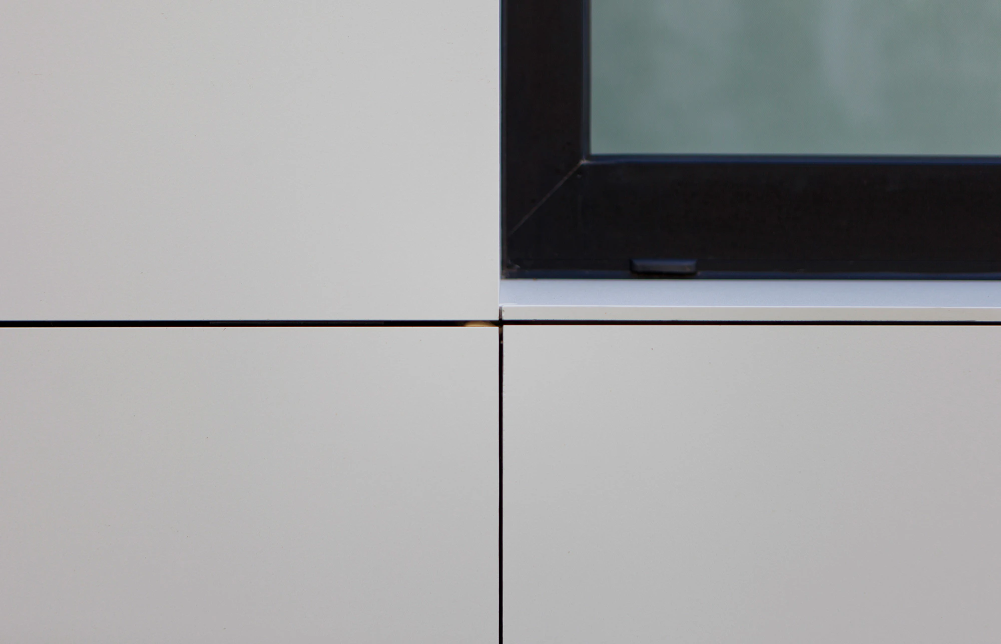 The white Dekton façade of this single-family house in Sanxenxo catches ...