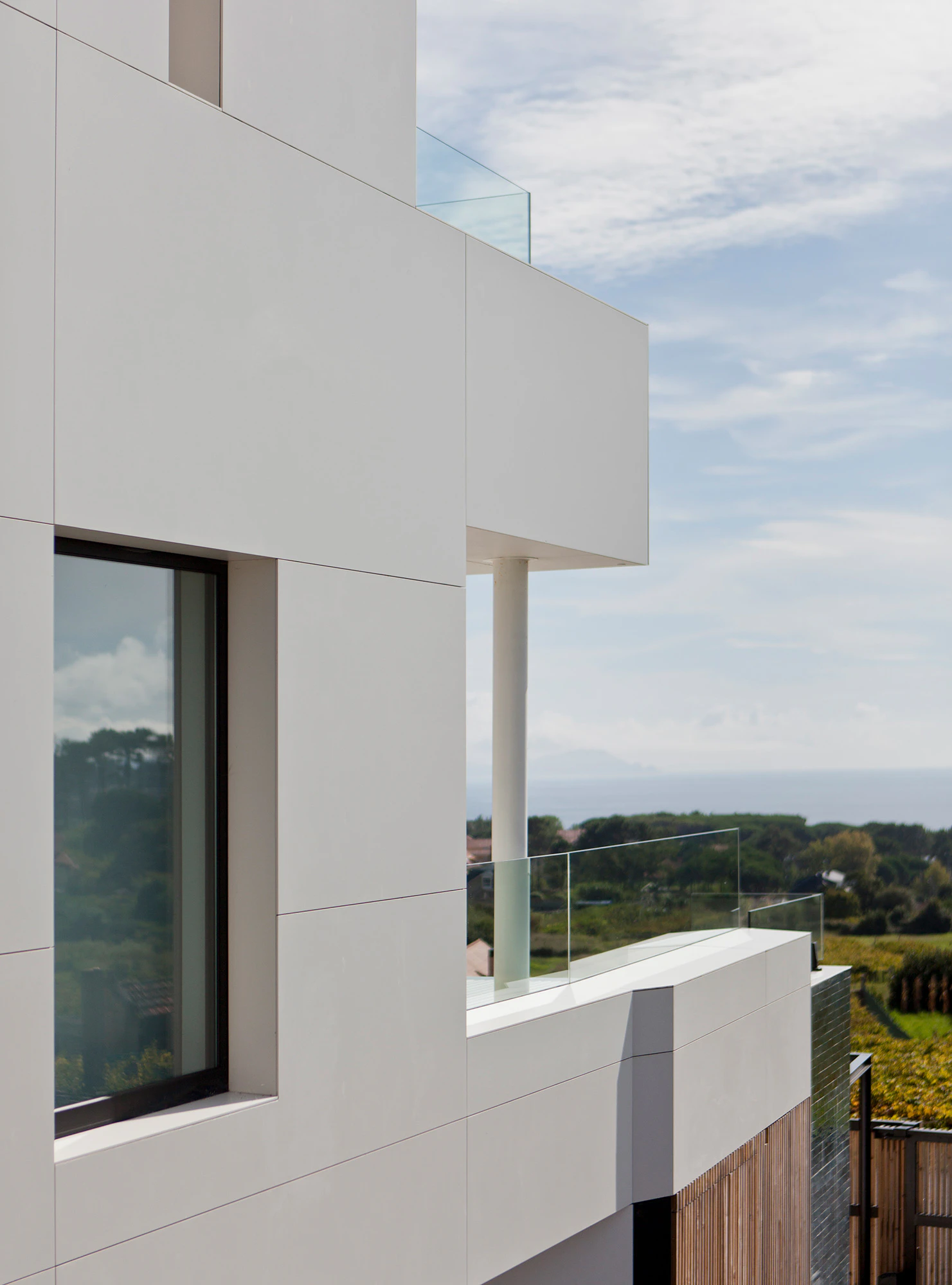 The white Dekton façade of this single-family house in Sanxenxo catches ...